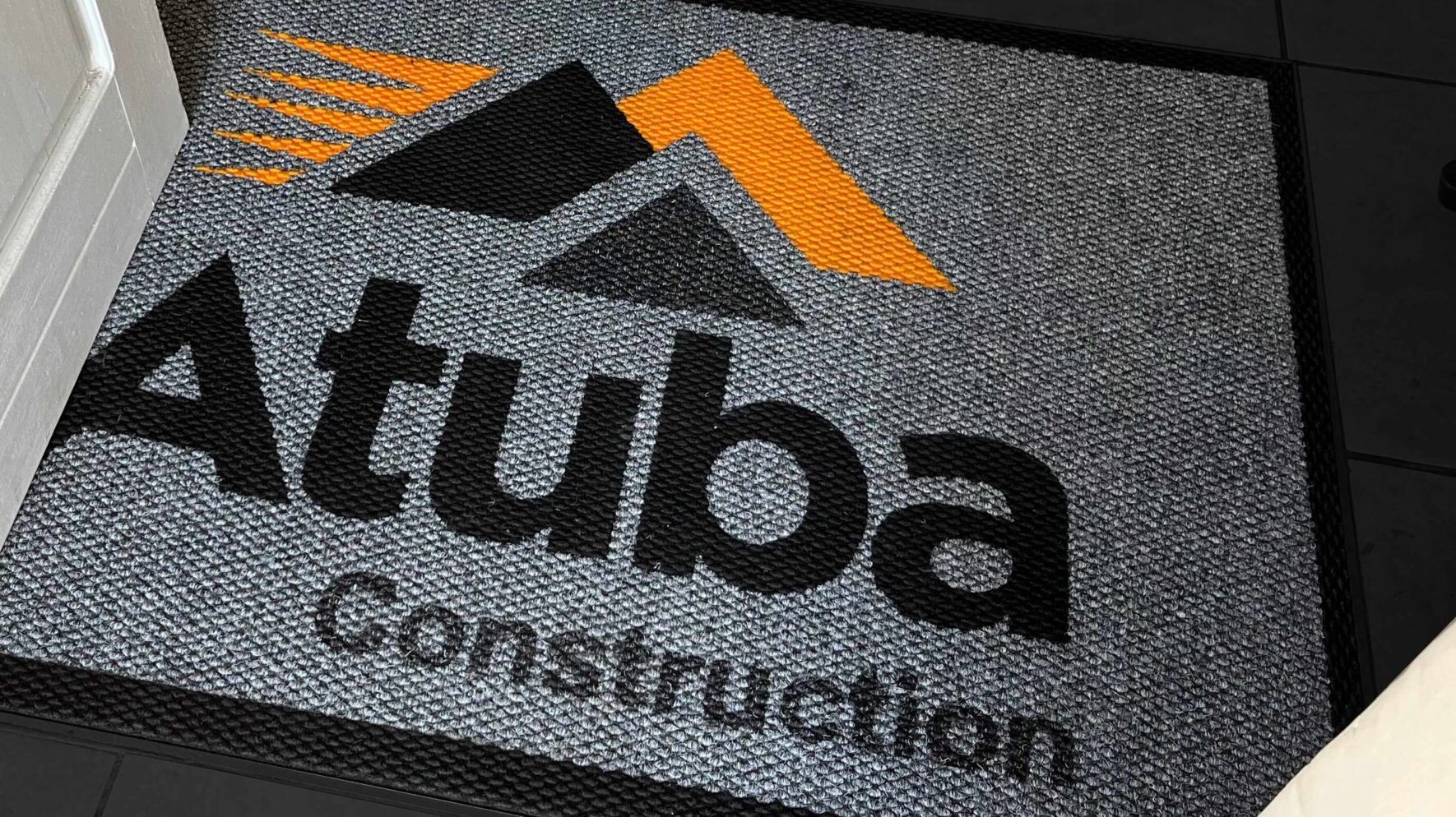 Atuba Construction upgrades with the logo entrance matting